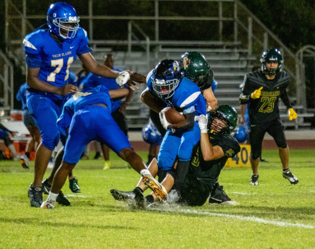 IN PICTURES: ’CANES VARSITY FOOTBALL CLOBBERS PALM GLADES