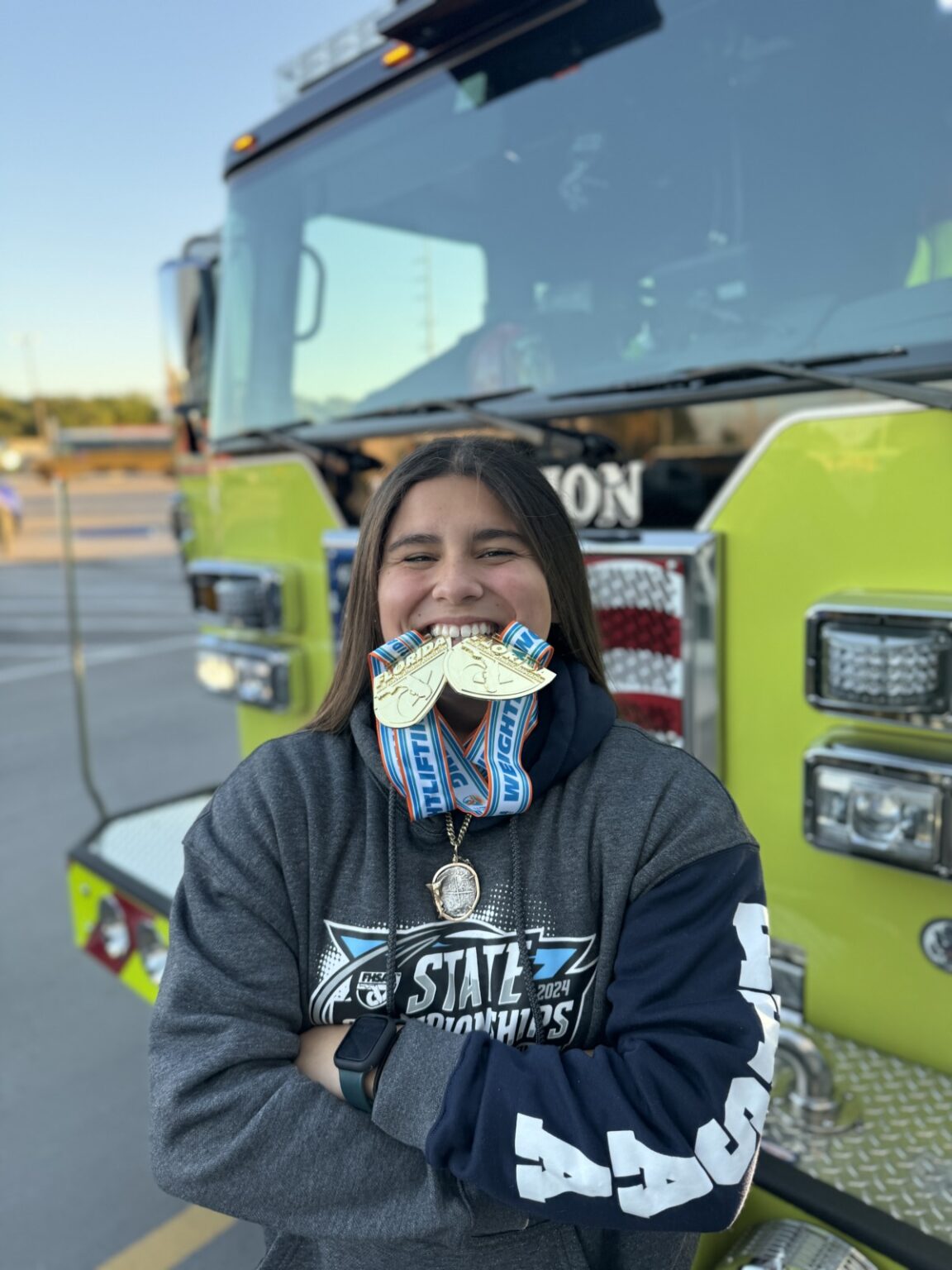 IN PICTURES: MEDAL-WINNING LADY FIN LIFTERS RETURN FROM STATE MEET IN STYLE