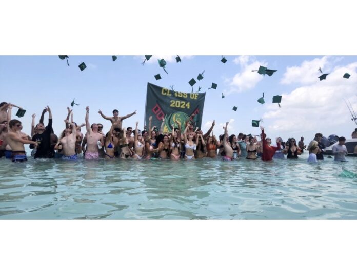 A CORAL SHORES TRADITION: SENIORS TOSS CAPS AT ISLAMORADA SANDBAR